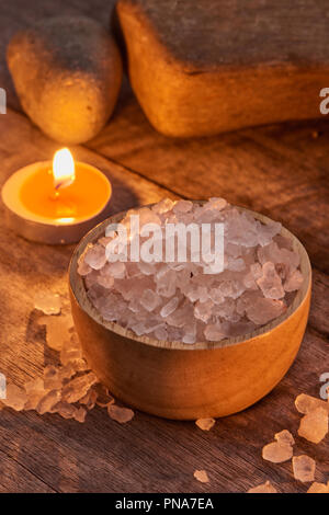 Spa treatment composition on wooden table, diffuser candles and pink ...