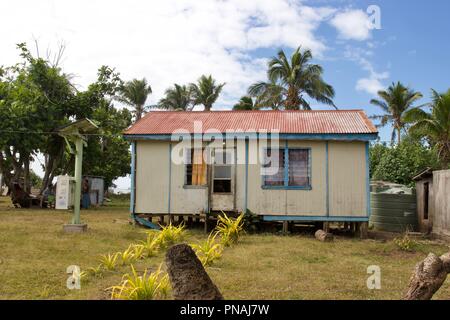 A family house with a corrugated roof inside a Tongan village on Atata ...