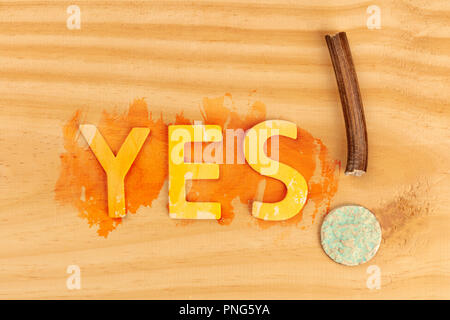 Yes, painted letters forming the word on a wooden background with copy ...