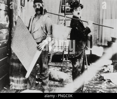 Silent Film Still. Silent film comedian Charlie Chaplin sitting on ...