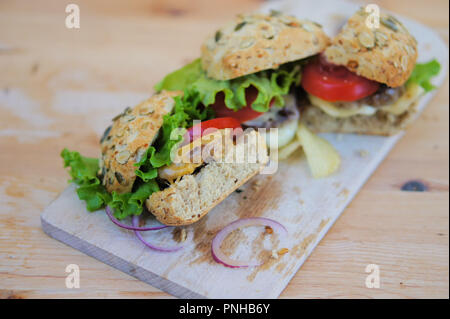 Several small cheeseburger sliders made from worm burger patties. The ...