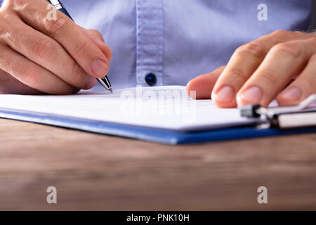 Male is signing agreement papers of financial nature at home Stock ...