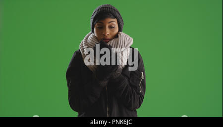 Shivering African American black woman in a short dress trying to keep ...