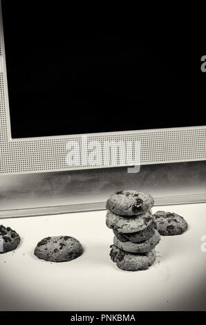 Cookies in front of a computer, a concept Stock Photo - Alamy