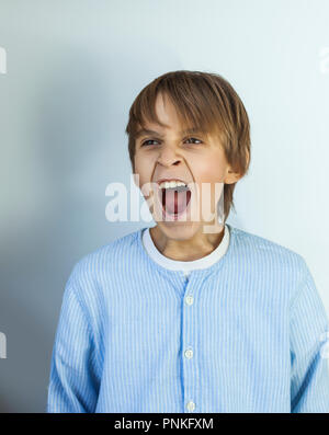 Emotional portrait of irritated shouting teen boy. Furious teenager ...