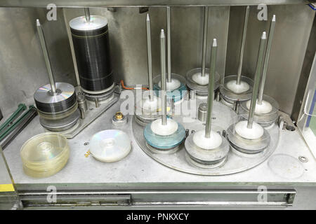 Compact disc and DVD at spindles in factory Stock Photo - Alamy