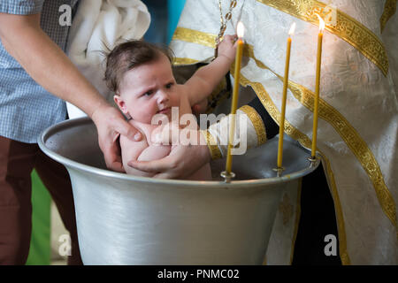 Baptism of a child. Ablution in holy water. Accepting faith. Orthodox ...