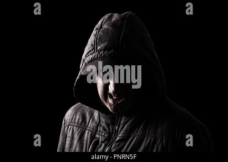 Very angry, aggressive, creepy man hiding the shadows, standing in the ...