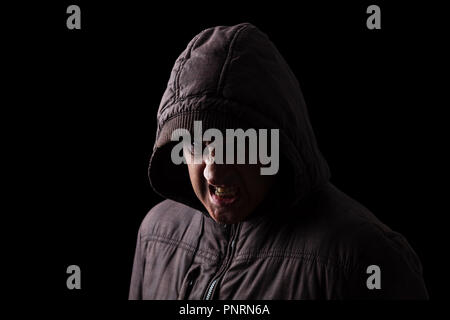 Very angry, aggressive, creepy man hiding the shadows, standing in the ...