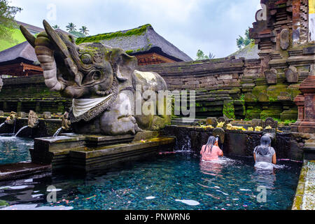 Balinese people taking a ritual purifying bath in holy spring water at ...