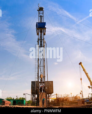 Workers at oil production site with crude oil pumps Stock Photo - Alamy