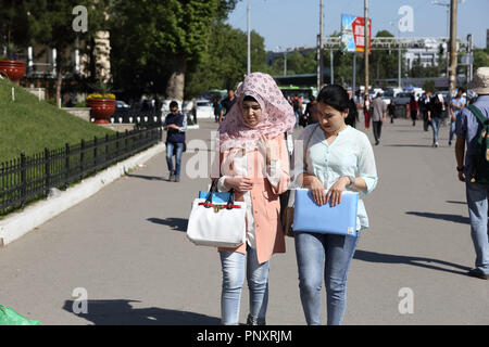 Two Uzbek women walking in street in a village near Samarkand in ...