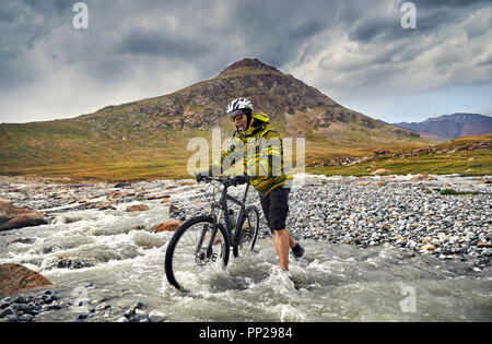 Road crossing the forest with cloudy sky and mountain view Stock Photo ...