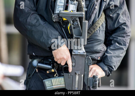 An Authorised Firearms Officer or AFO of the British police holding a ...