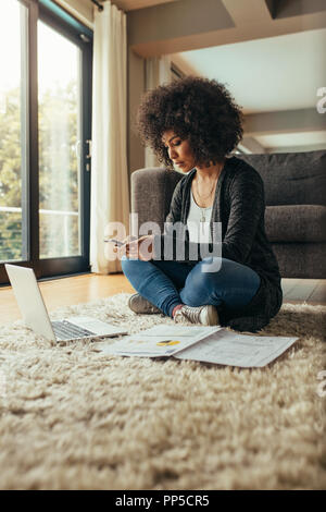 Freelancer using laptop lying on wall Stock Photo - Alamy