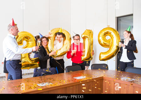 Business people celebrating 2019 New Year at office party Stock Photo ...