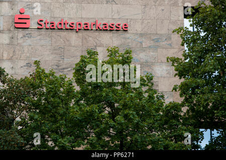 A logo sign outside of the headquarters of Stadtsparkasse München in ...
