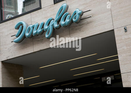 A logo sign outside of a Douglas cosmetics retail store in Munich ...