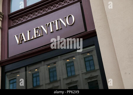 A logo sign outside of a Valentino retail store in Munich, Germany, on ...