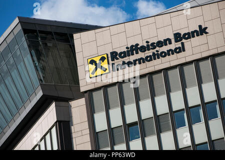 A logo sign outside of the headquarters of Raiffeisen Bank ...