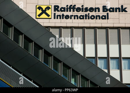 A logo sign outside of the headquarters of Raiffeisen Bank ...