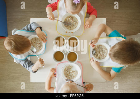 Preschool children eating breakfast in the school classroom Stock Photo ...