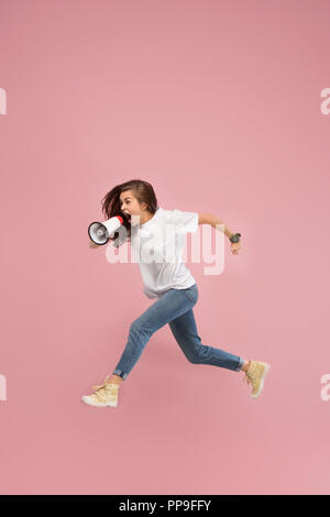Young woman shouting in megaphone, technology announcement concept ...