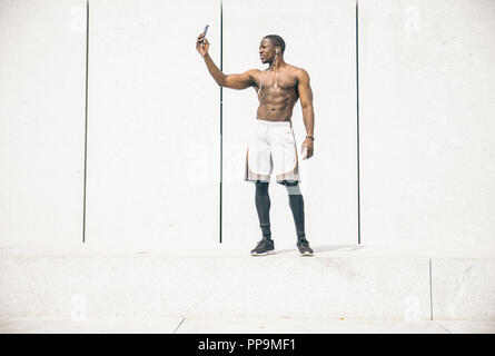 Sportive man training outdoors and having a rest Stock Photo - Alamy