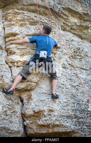 Photo of strong young sports man make stretching exercises at stadium ...