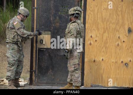 A Dutch Soldier uses an M500 shotgun to breach a door during the Urban ...