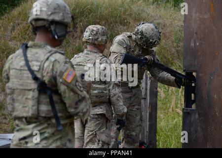 A Dutch Soldier uses an M500 shotgun to breach a door during the Urban ...