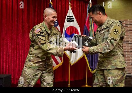 Col. Chul Kim, U.S. Army Pacific chaplain, gives Maj. Gen. Tom Solhjem ...