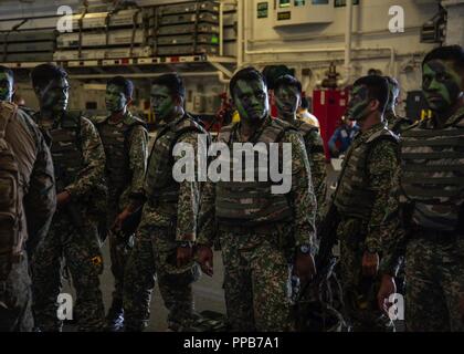 SULU SEA (Aug. 17, 2018) –Royal Malaysian marines discuss an upcoming ...