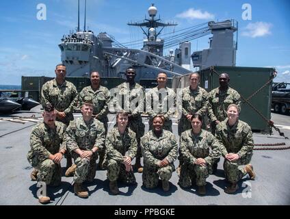 Members of the US Navy Amphibious Construction Battalion 2, off-load a ...
