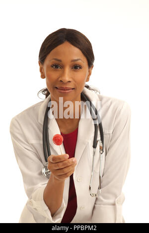 Young doctor woman holding sweets candy looking positive and happy ...