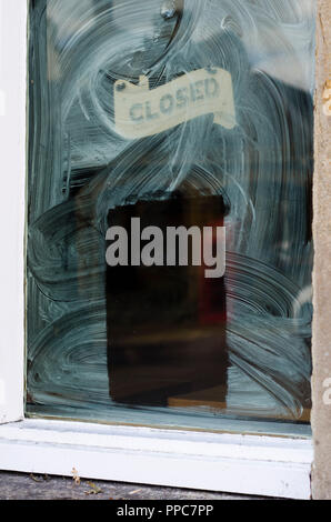 Trouble on the high street premises closed with white washed windows ...