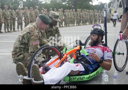 Retired Command Sgt. Maj. Kenneth “Rock” Merritt signs posters after ...