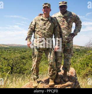 U.S. Army Csm. Jerimiah Gan and Csm. Edward Mitchel, pose on top of a rock during Drill Sergeant ...