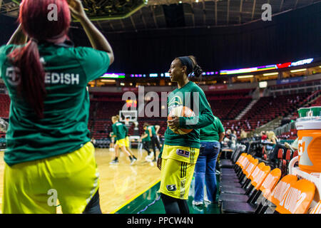 Basketball players warming up before game in basketball court Stock ...