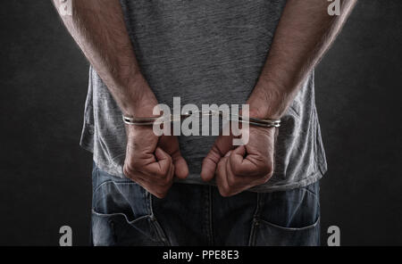 Handcuffs on the hand. The hand is handcuffed to the radiator of the ...