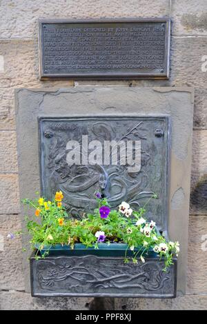 The Witches Well is a cast iron fountain set in the wall near the ...