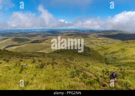 A hiker climbs the slopes of Mt Inyangani in bad weather, Nyanga ...