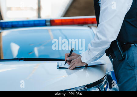 Police officer writing on a clipboard wearing a NYPD uniform Stock ...