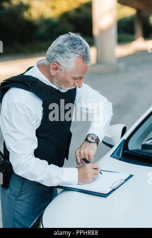 Police officer writing on a clipboard wearing a NYPD uniform Stock ...