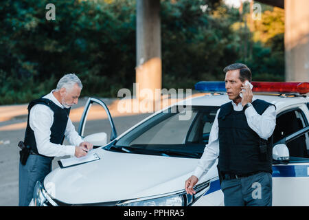 Police officer writing on a clipboard wearing a NYPD uniform Stock ...