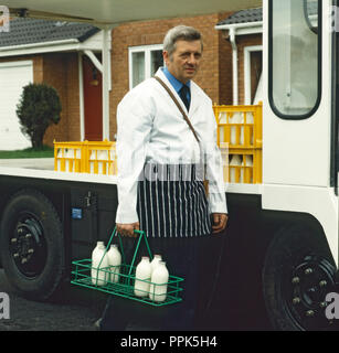 Doorstep milk delivery with milkman and milk float Stock Photo - Alamy