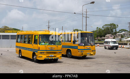 Barbados Yellow buses waiting at bus stop Stock Photo - Alamy