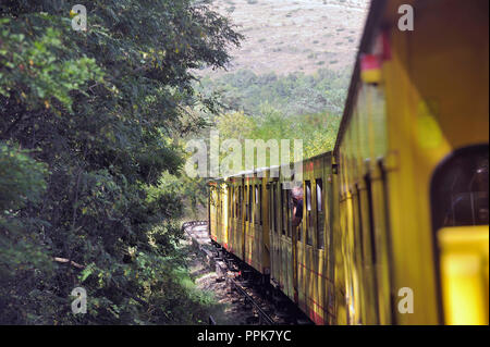 The small yellow train of the Pyrenees crossing a beautiful mountain ...