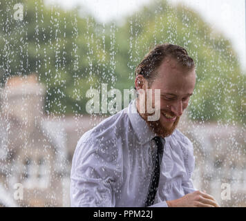 A man in a suit caught in a very heavy rain shower Stock Photo - Alamy