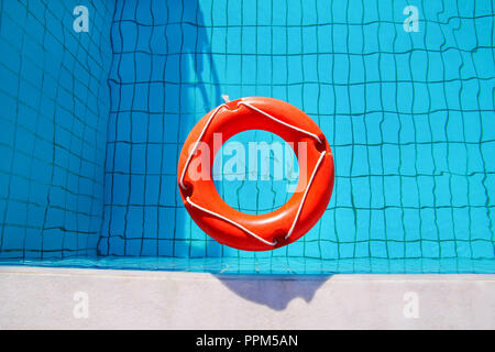 Red lifebuoy pool ring float, ring floating in refreshing blue swimming ...